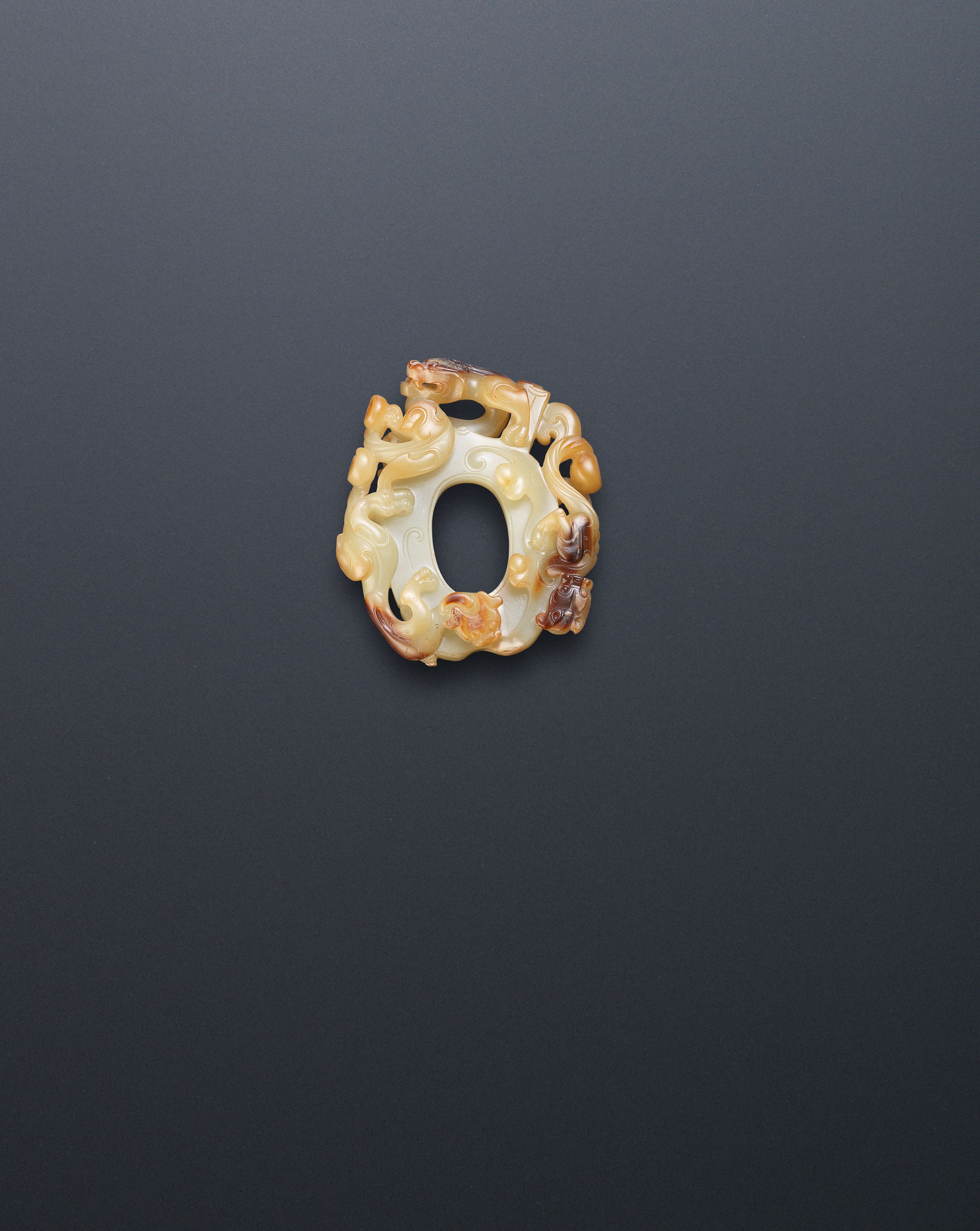 Bonhams : A yellow and russet jade archaistic 'chi dragon' disc, bi ...