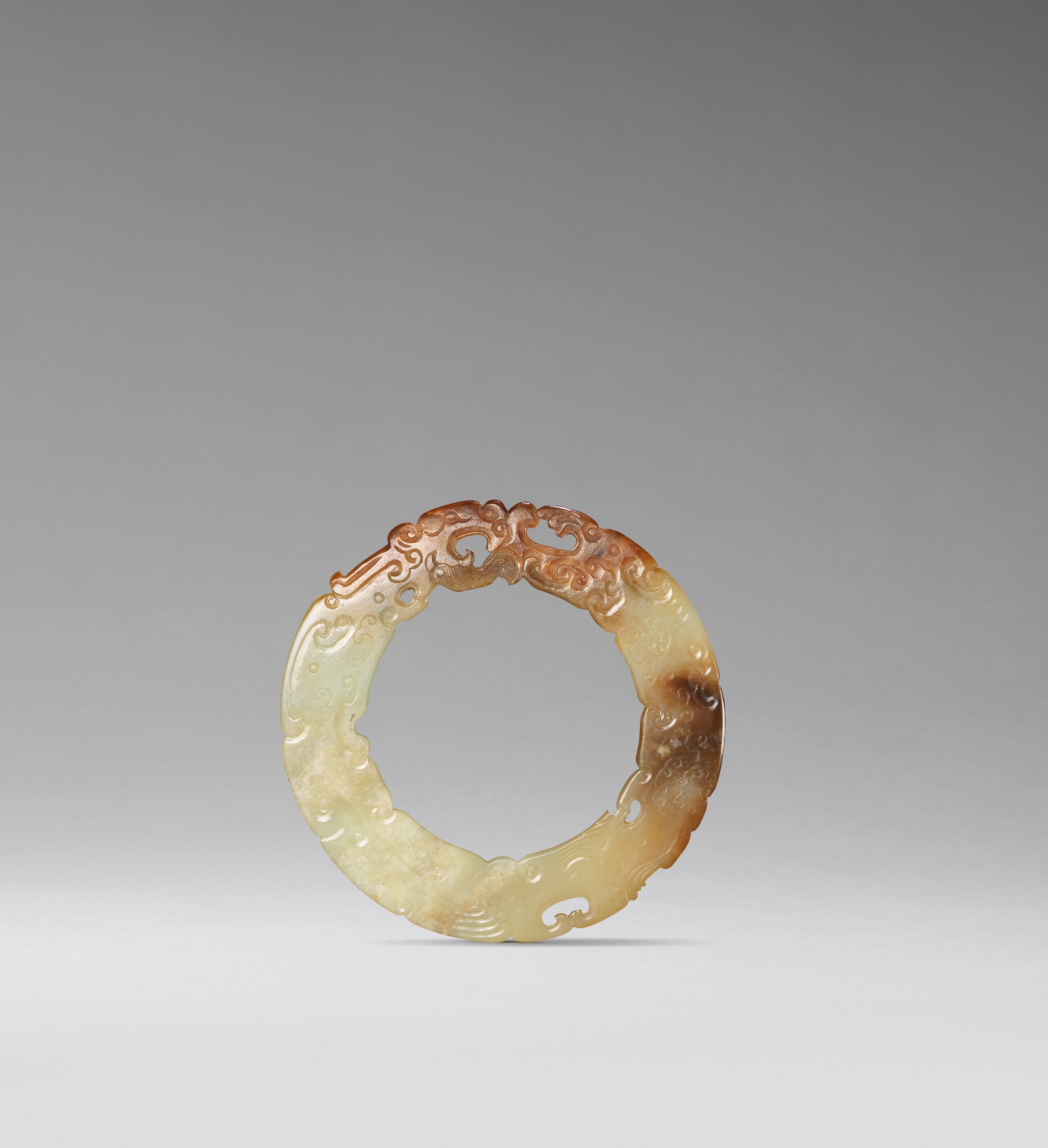 Bonhams : A rare archaistic pale green and russet jade 'double-dragon ...