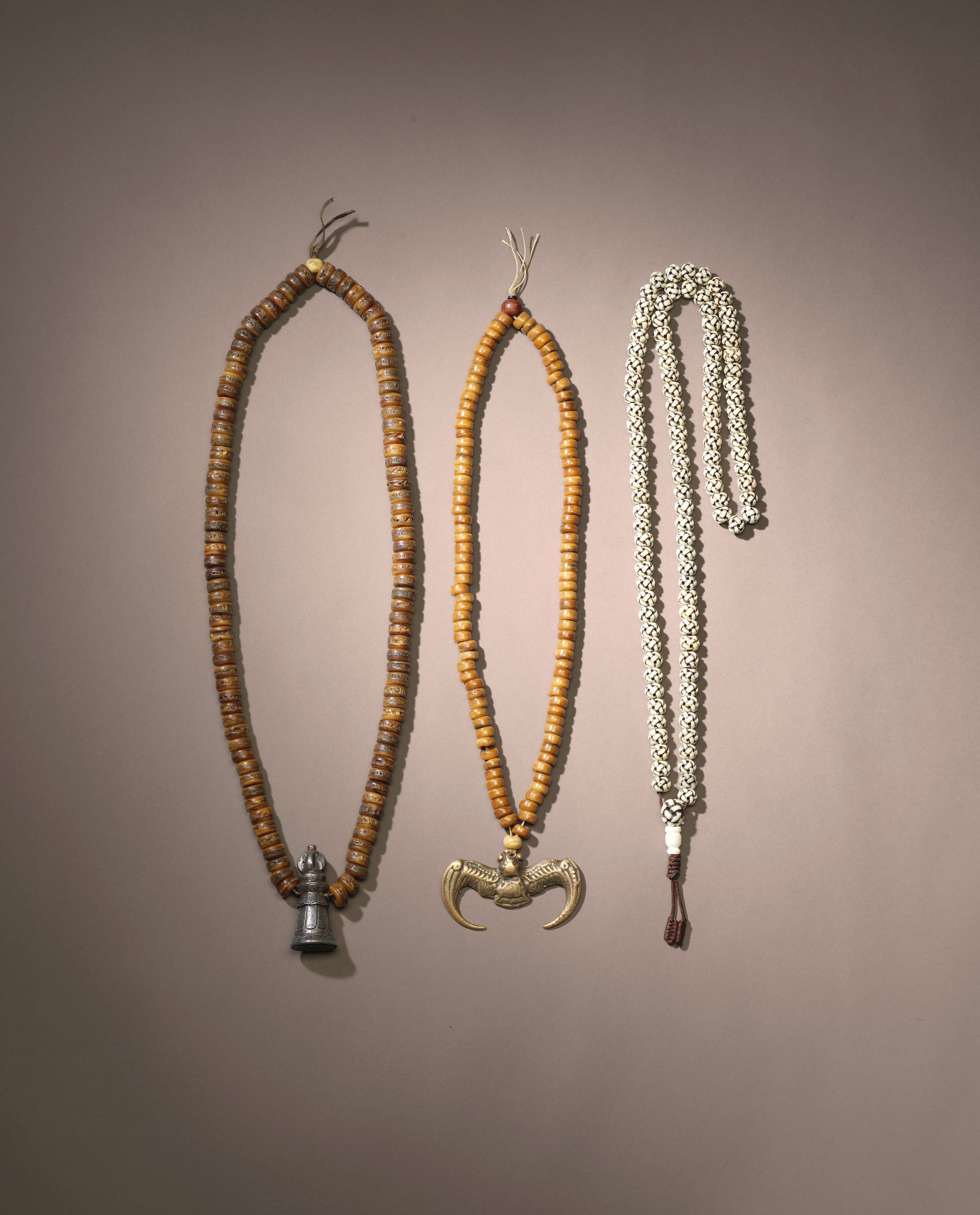 Bonhams : A GROUP OF THREE BONE MALAS