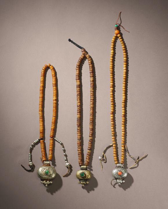 Bonhams : A GROUP OF THREE BONE MALAS WITH GAUS