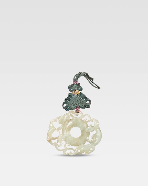 Bonhams : A pale green jade reticulated 'chilong' disc, bi Ming Dynasty