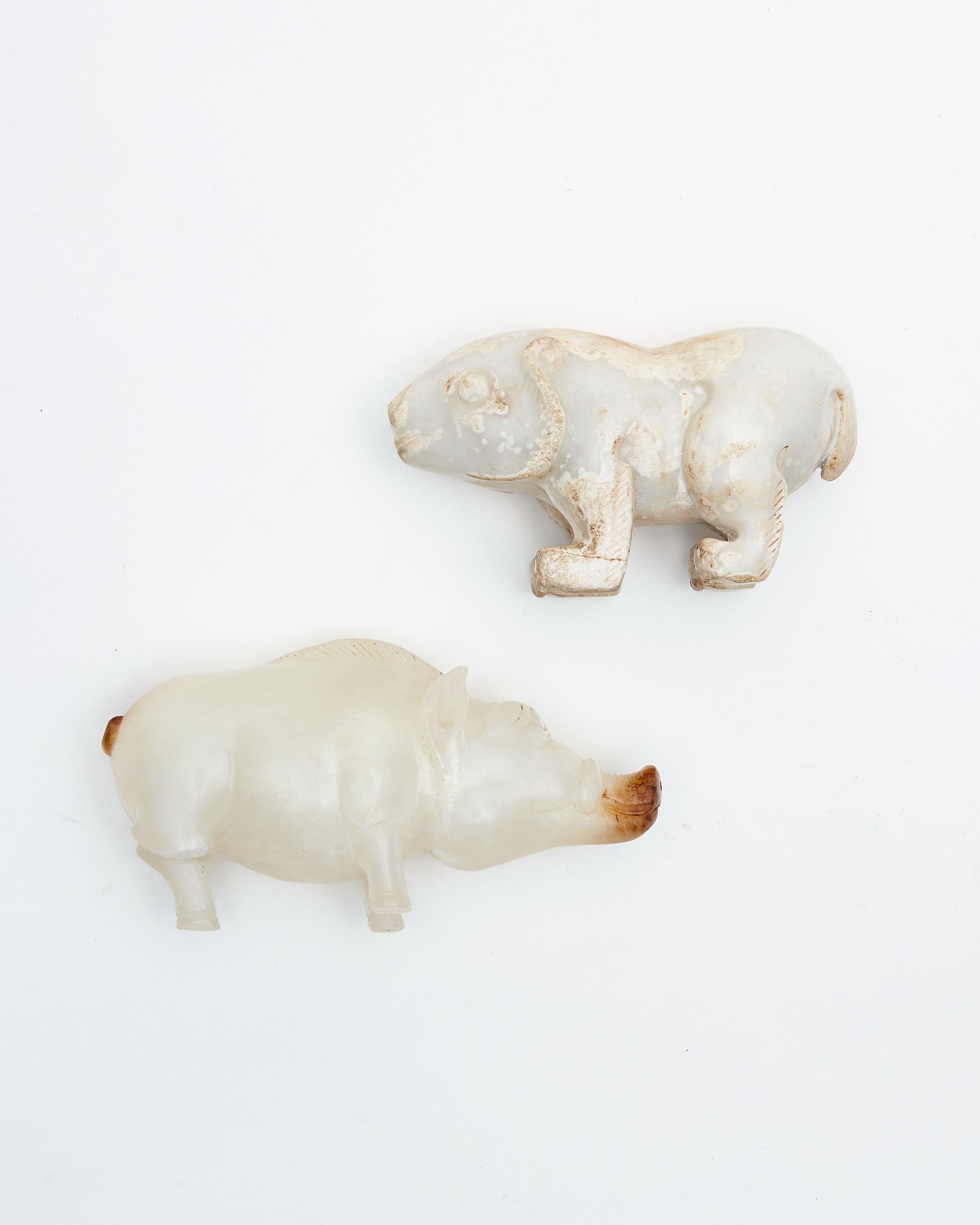 Bonhams : Two white jade carvings of a bear and a boar 19th/ 20th century