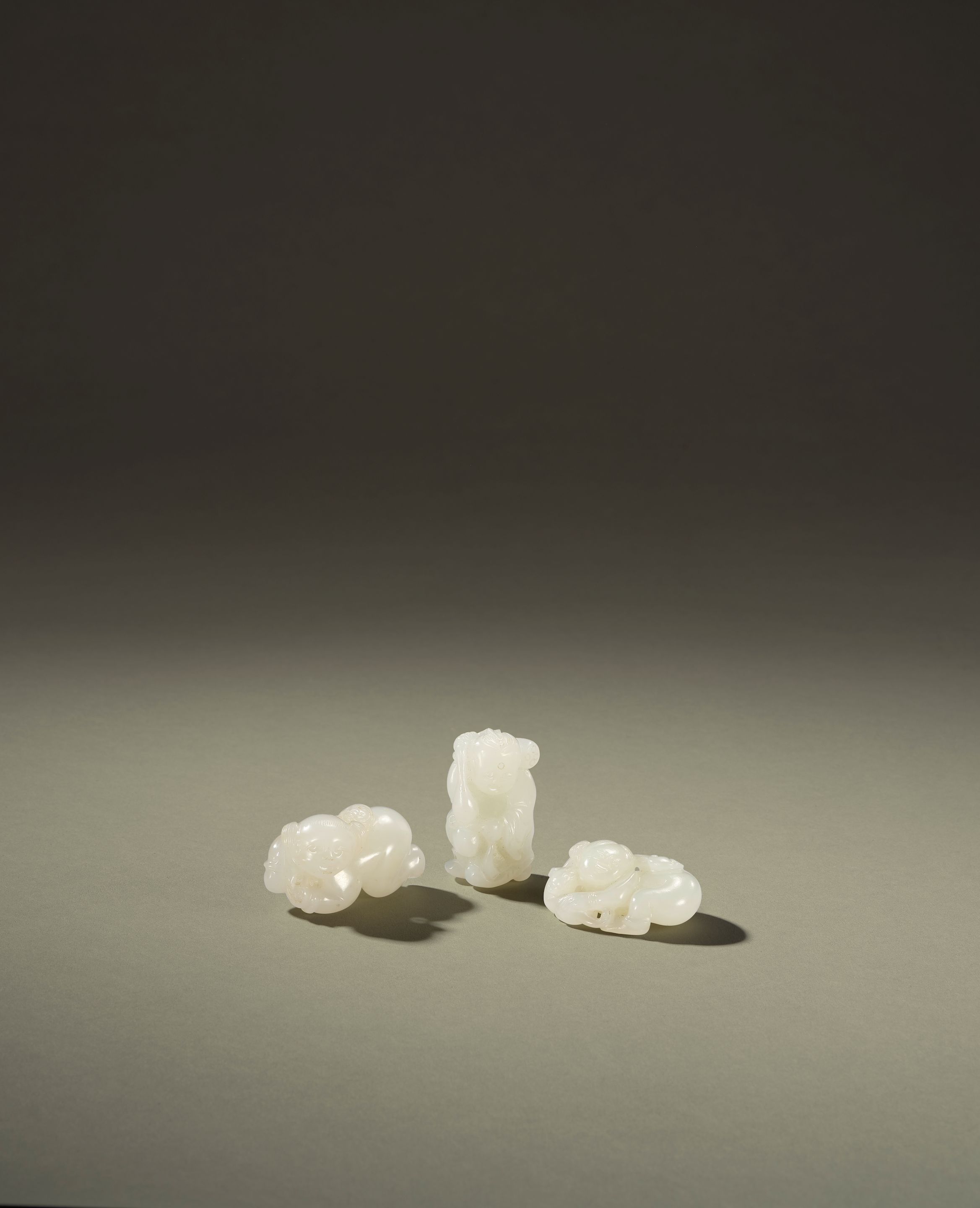 Bonhams : A GROUP OF THREE SMALL WHITE JADE 'BOY' CARVINGS 18th/19th ...