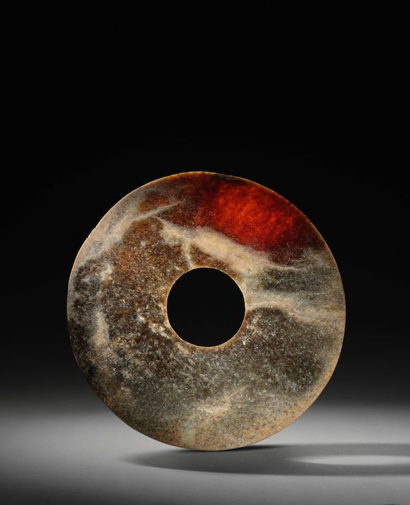 Bonhams : A LARGE BUFF AND ALTERED RED JADE DISC, BI Northwest China ...