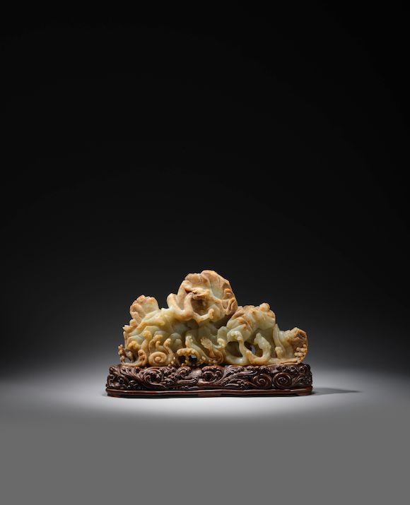 Bonhams : A RARE PALE GREEN AND RUSSET JADE 'DRAGON' BRUSHREST Ming Dynasty