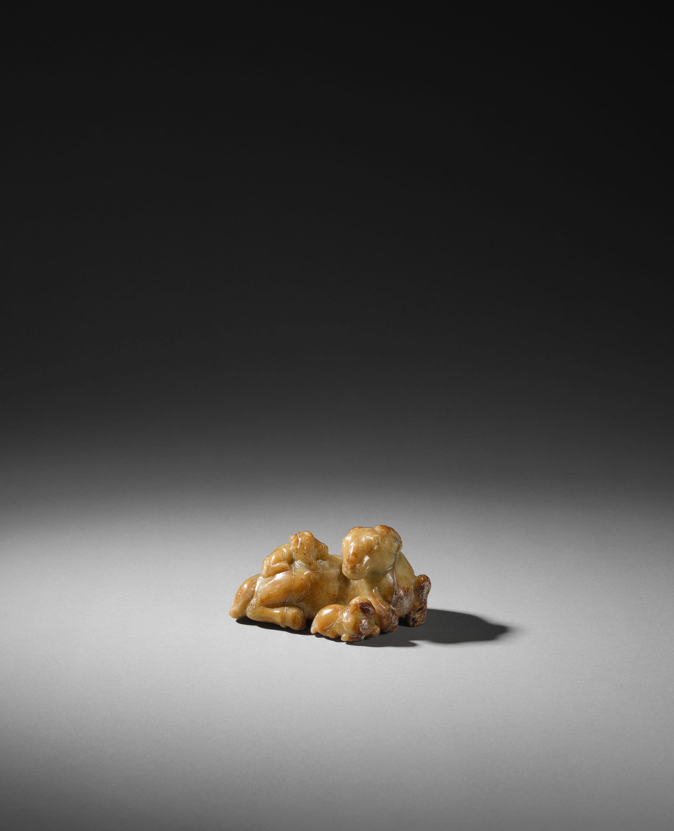 Bonhams : A BROWN JADE 'THREE RAMS' GROUP Ming Dynasty