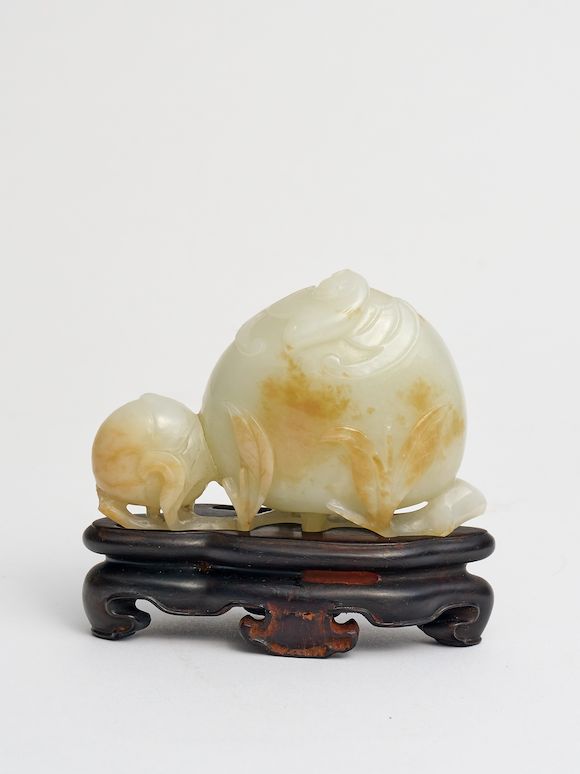 Bonhams : A pale celadon jade 'peaches and bat' carving 18th/19th century